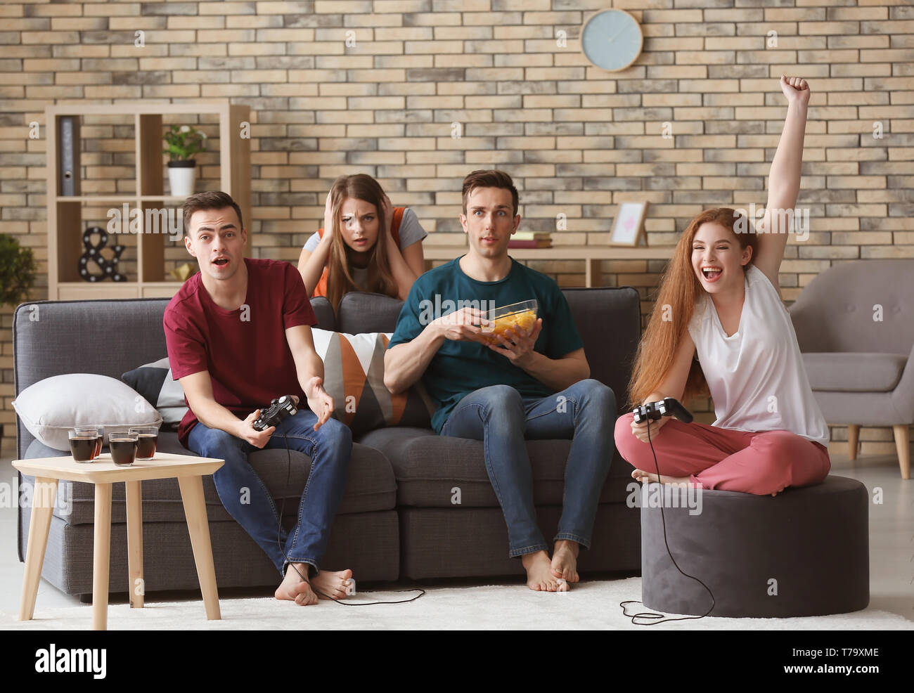 Young people playing video games at home Stock Photo - Alamy