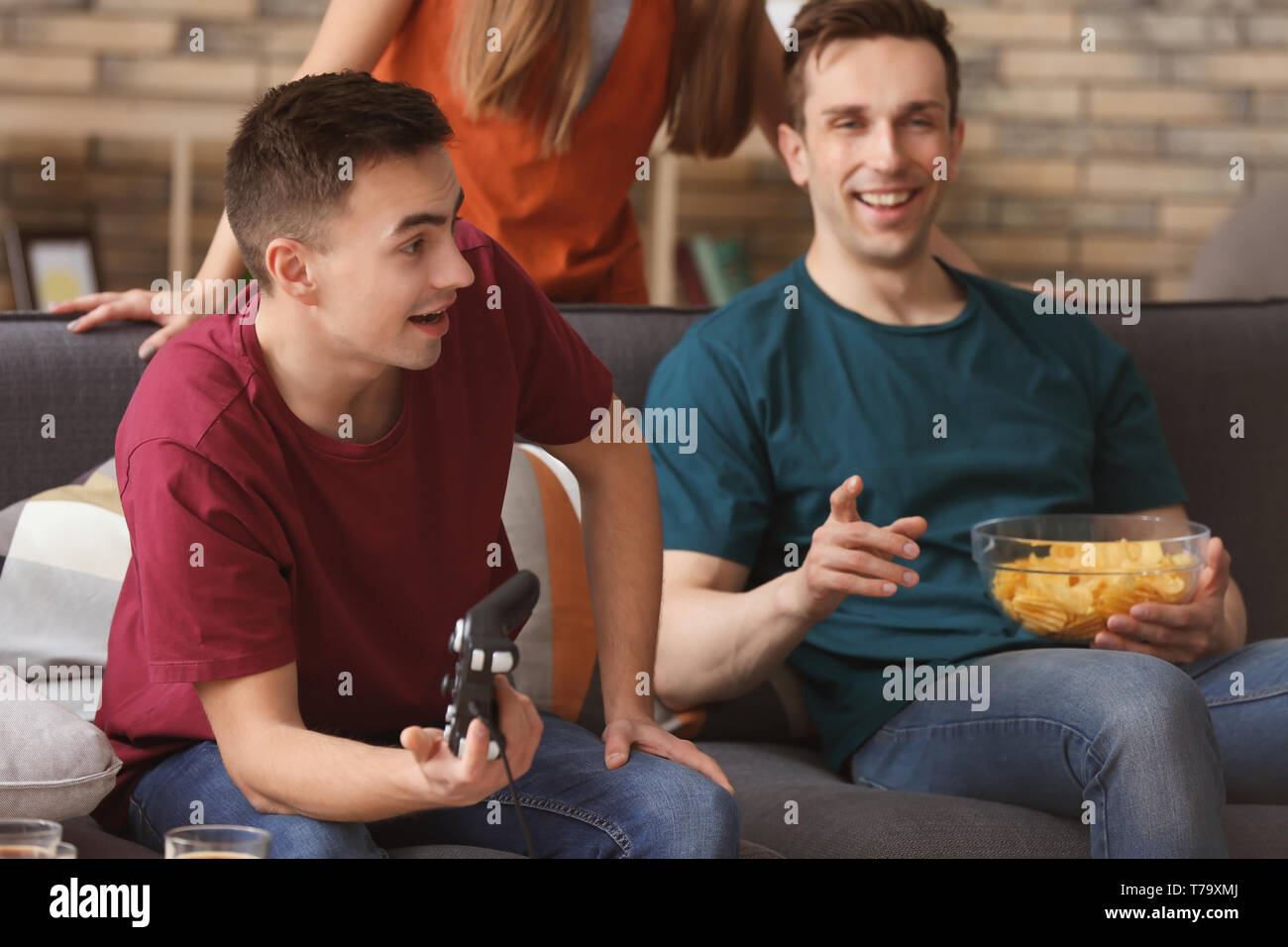 Young people playing video games at home Stock Photo - Alamy