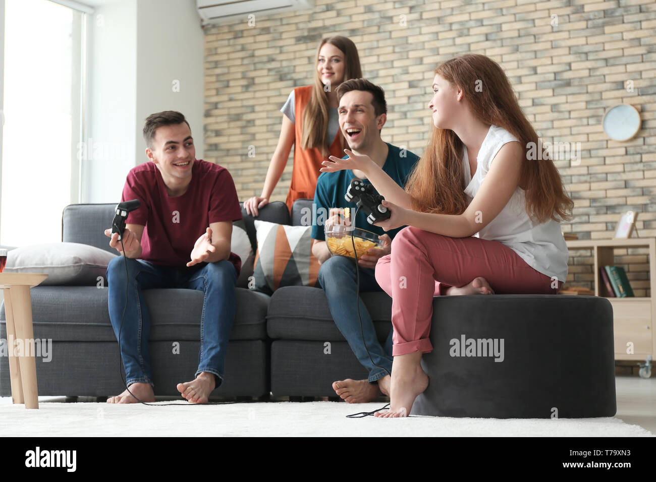 Young people playing video games at home Stock Photo - Alamy