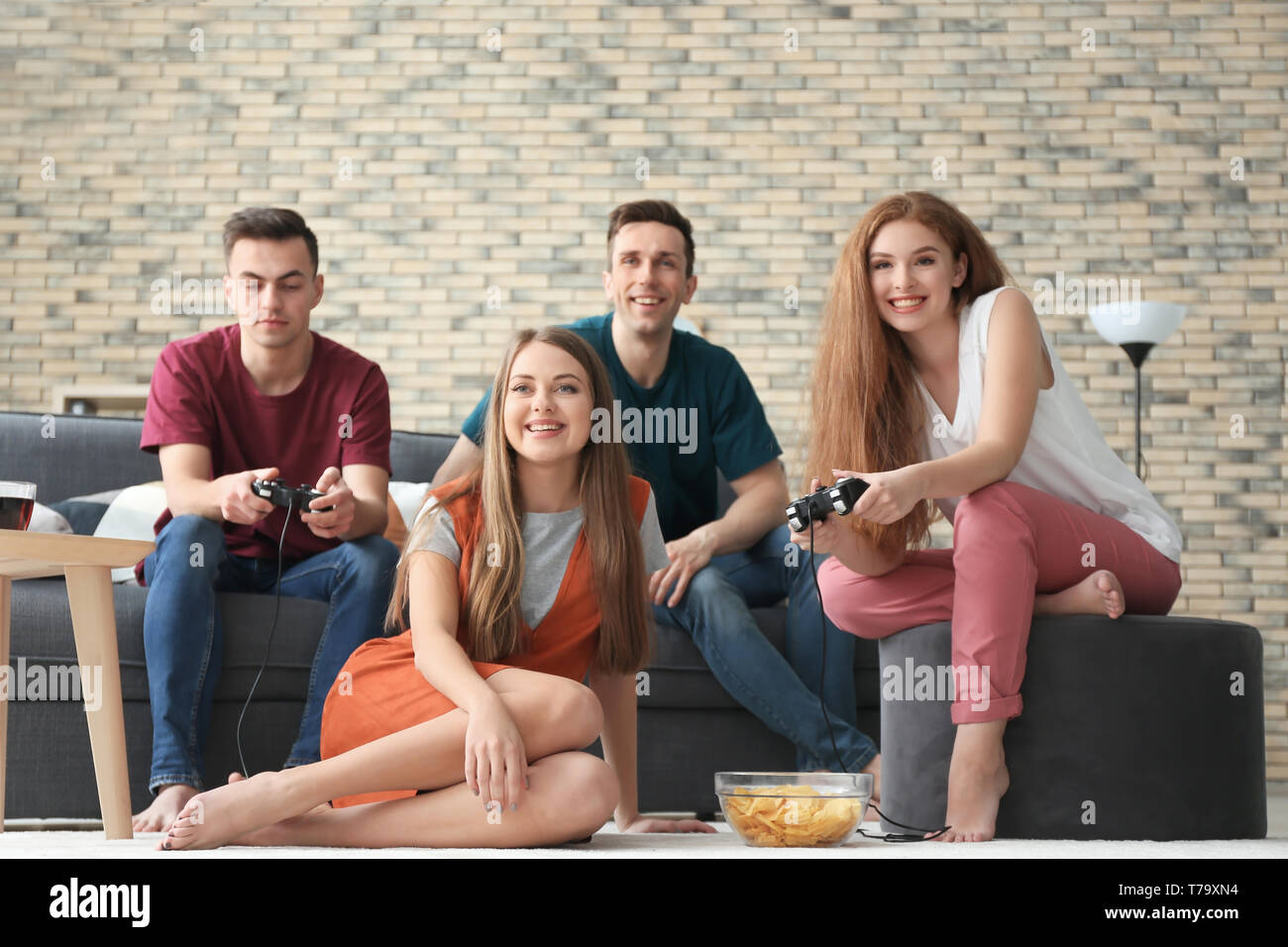 Young people playing video games at home Stock Photo - Alamy