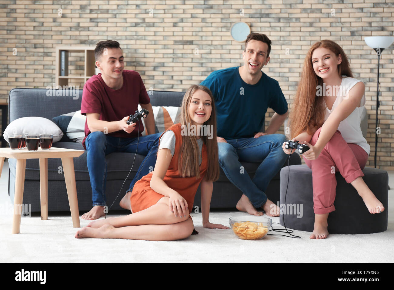 Young people playing video games at home Stock Photo - Alamy