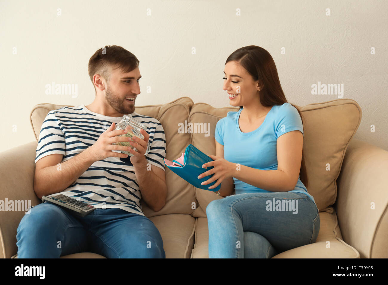 Young couple counting money indoors. Money savings concept Stock Photo ...