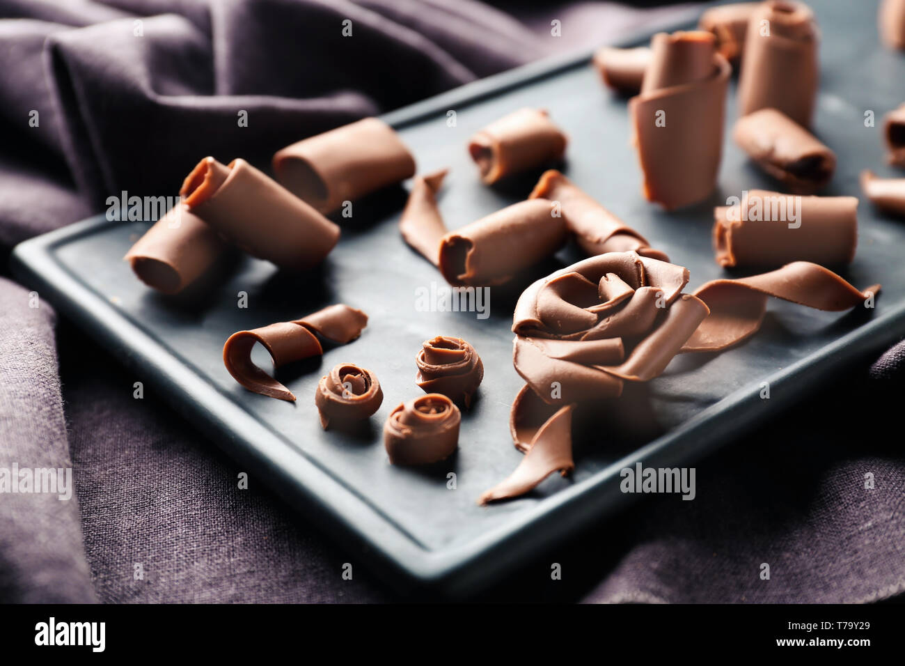 Delicious chocolate curls on board Stock Photo - Alamy