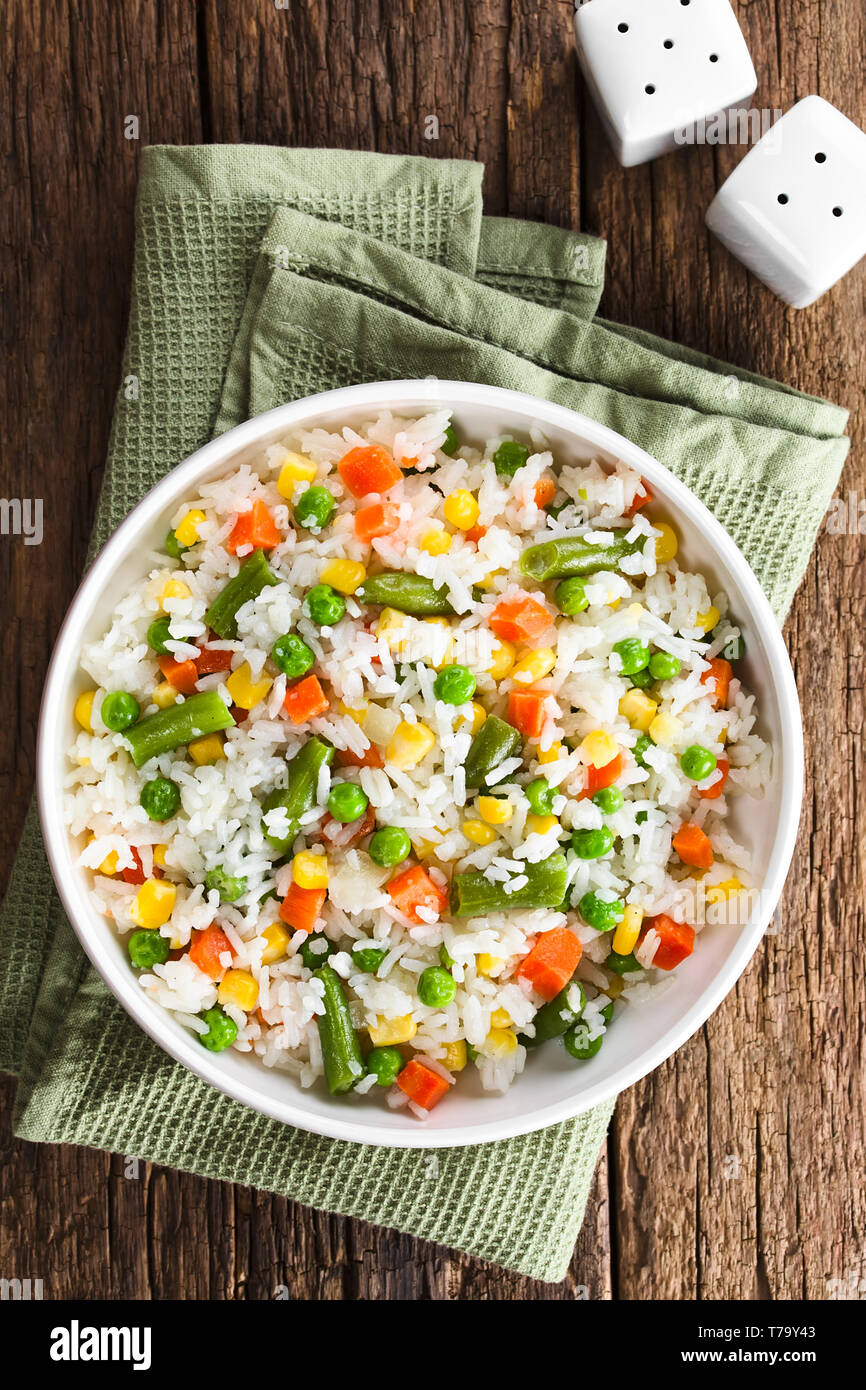 Cooked white rice mixed with colorful vegetables (onion, carrot, green ...
