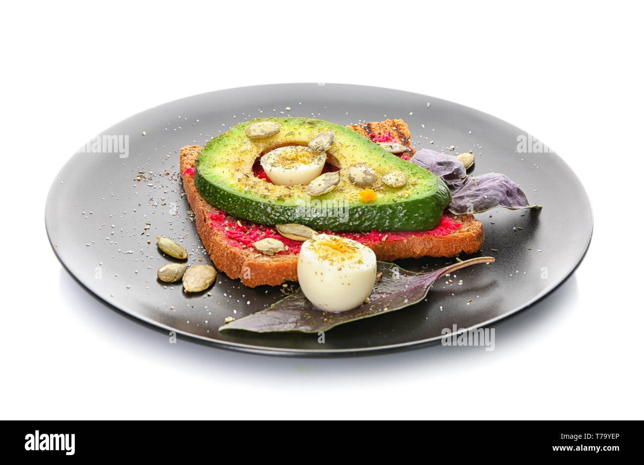 Delicious toast with avocado on plate, isolated on white Stock Photo ...