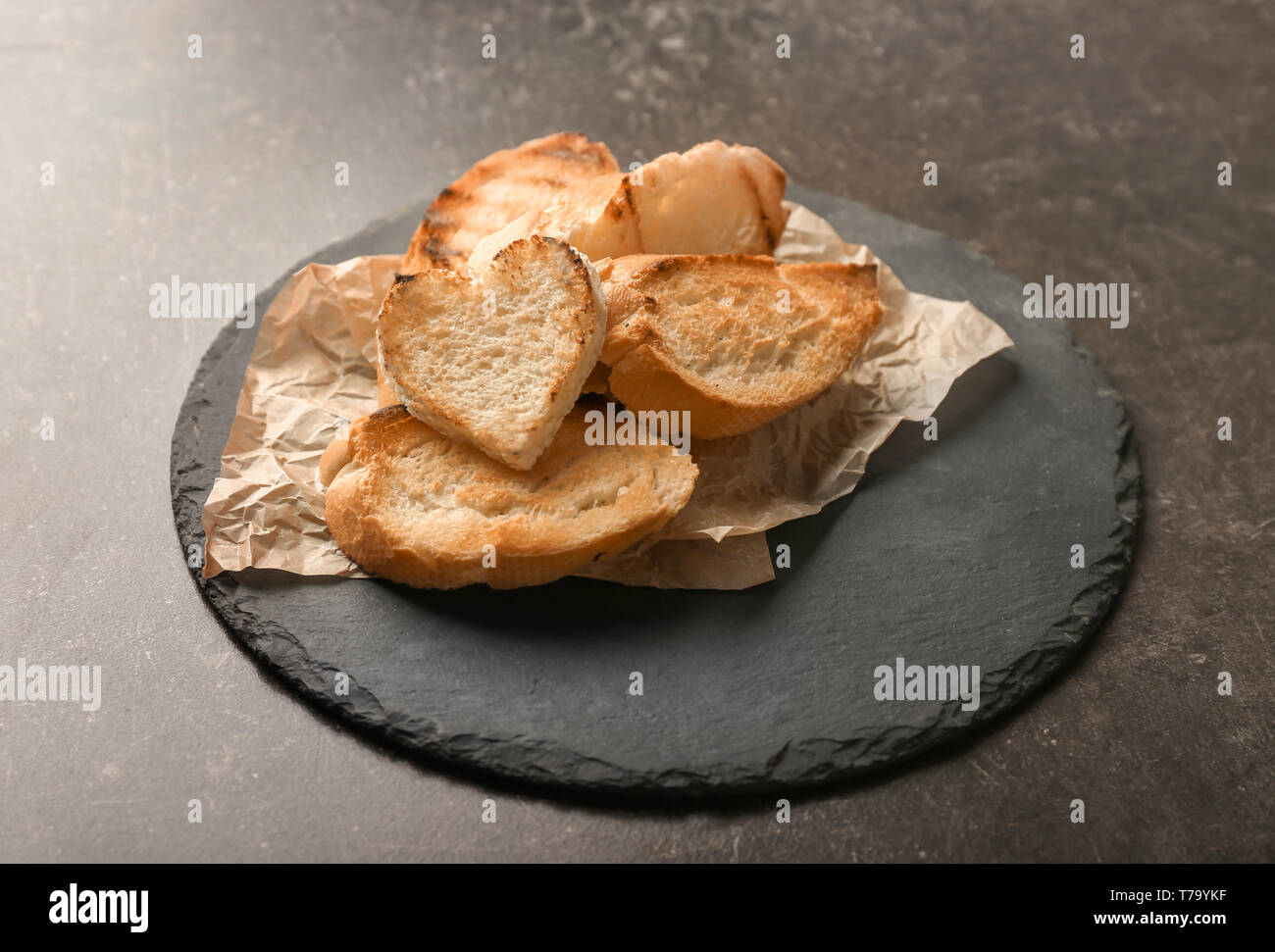 Tasty toasted bread on slate plate Stock Photo - Alamy