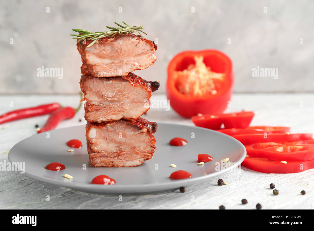 Plate with stack of delicious grilled ribs on table Stock Photo - Alamy