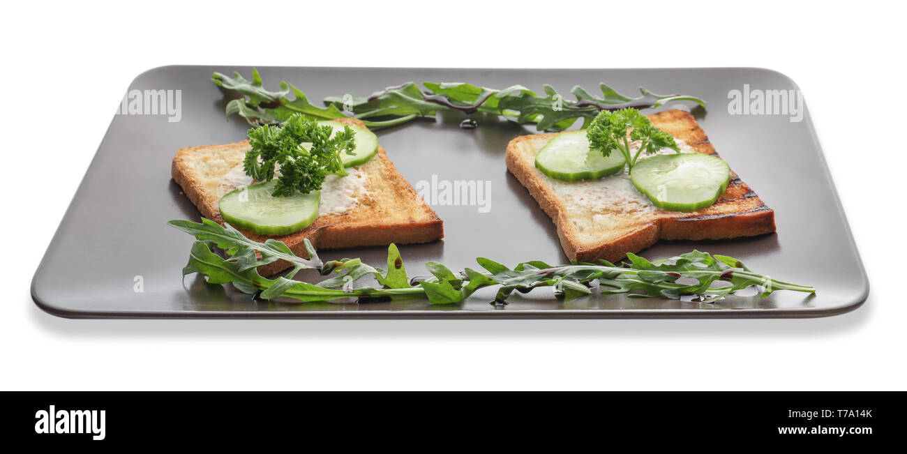 Toasted bread with cucumber on plate, isolated on white Stock Photo - Alamy