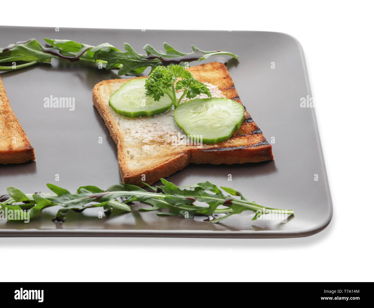 Toasted bread with cucumber on plate, isolated on white Stock Photo - Alamy