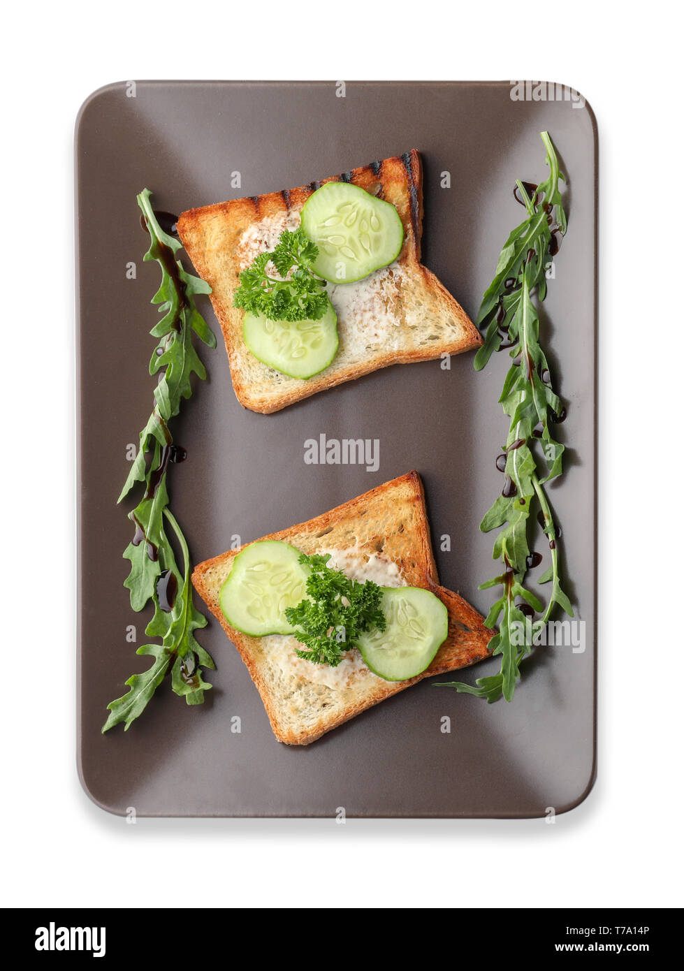 Toasted bread with cucumber on plate, isolated on white Stock Photo - Alamy