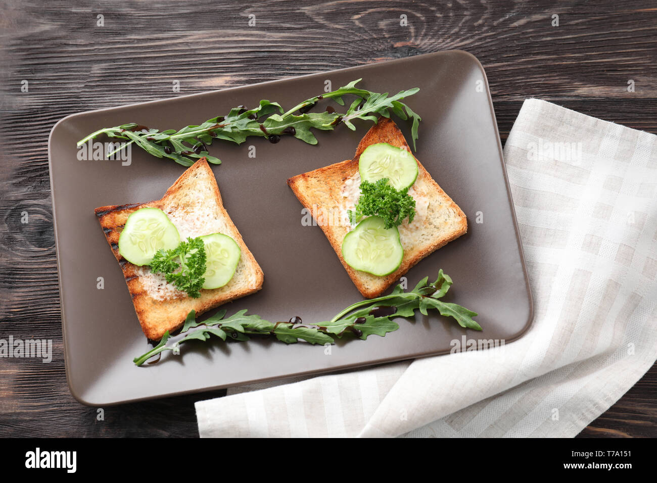Toasted bread with cucumber on plate Stock Photo - Alamy