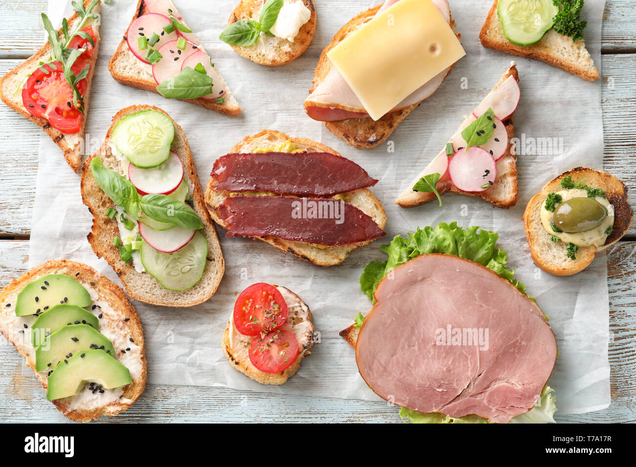 Different delicious toasts on table Stock Photo - Alamy