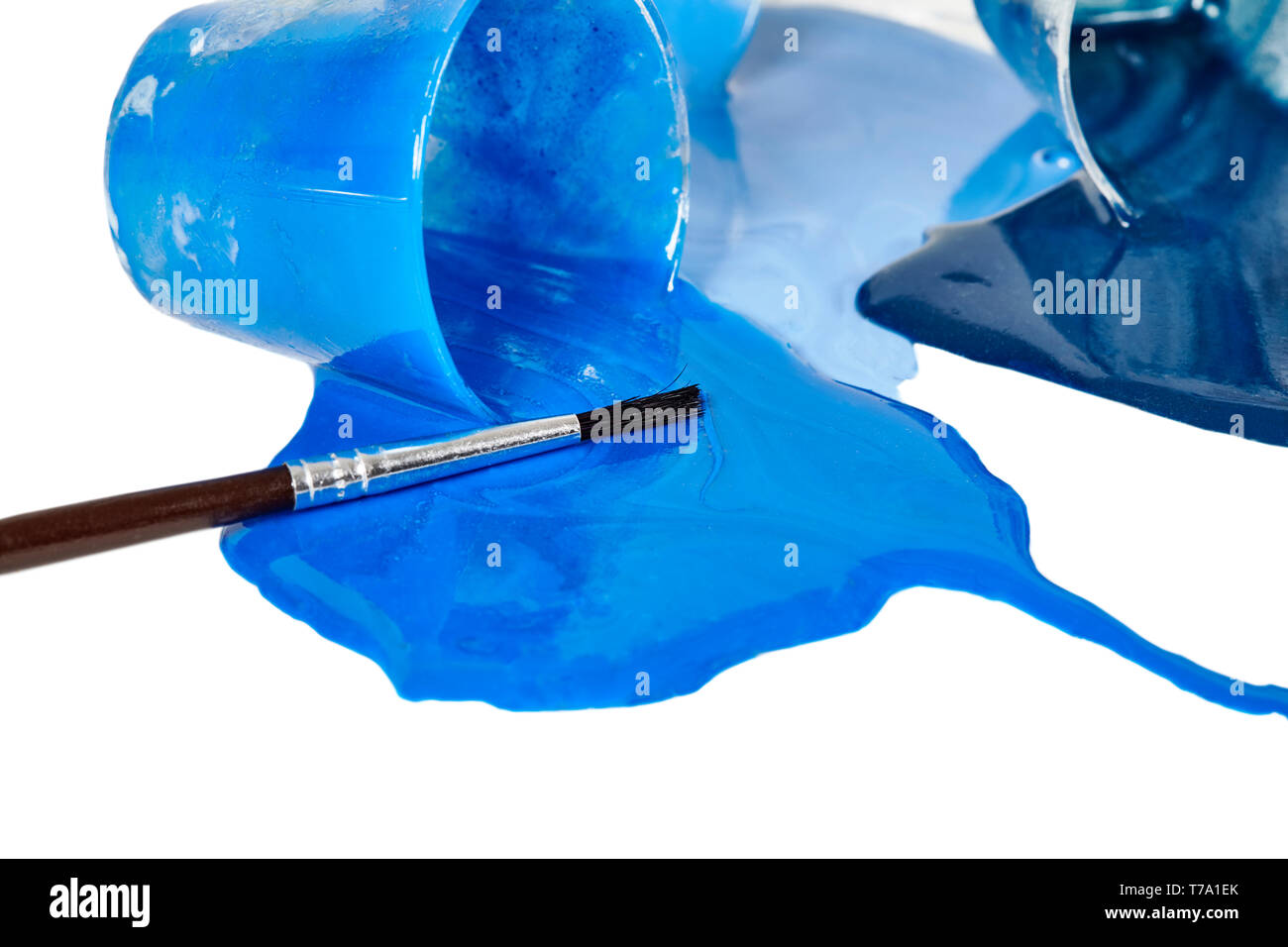 Small bowl of shades of blue acrylic paint laying on its side wtih an ...