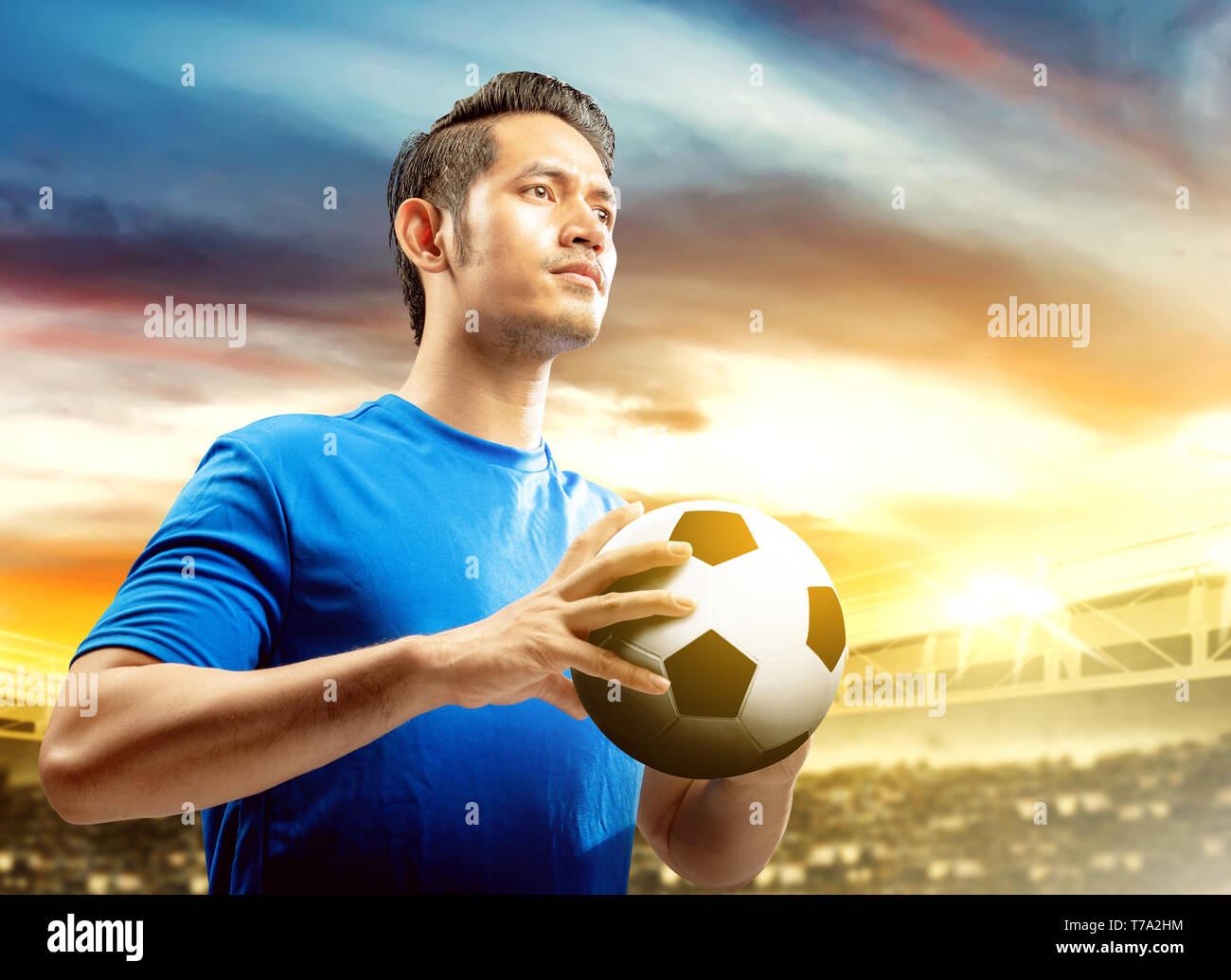 Asian football player man in blue jersey holding the ball on the ...