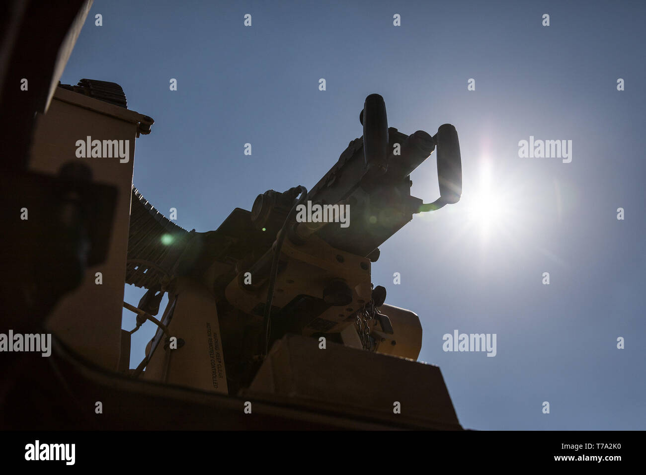A U.S. Army Soldier uses a remote control to traverse an M2 .50 caliber ...
