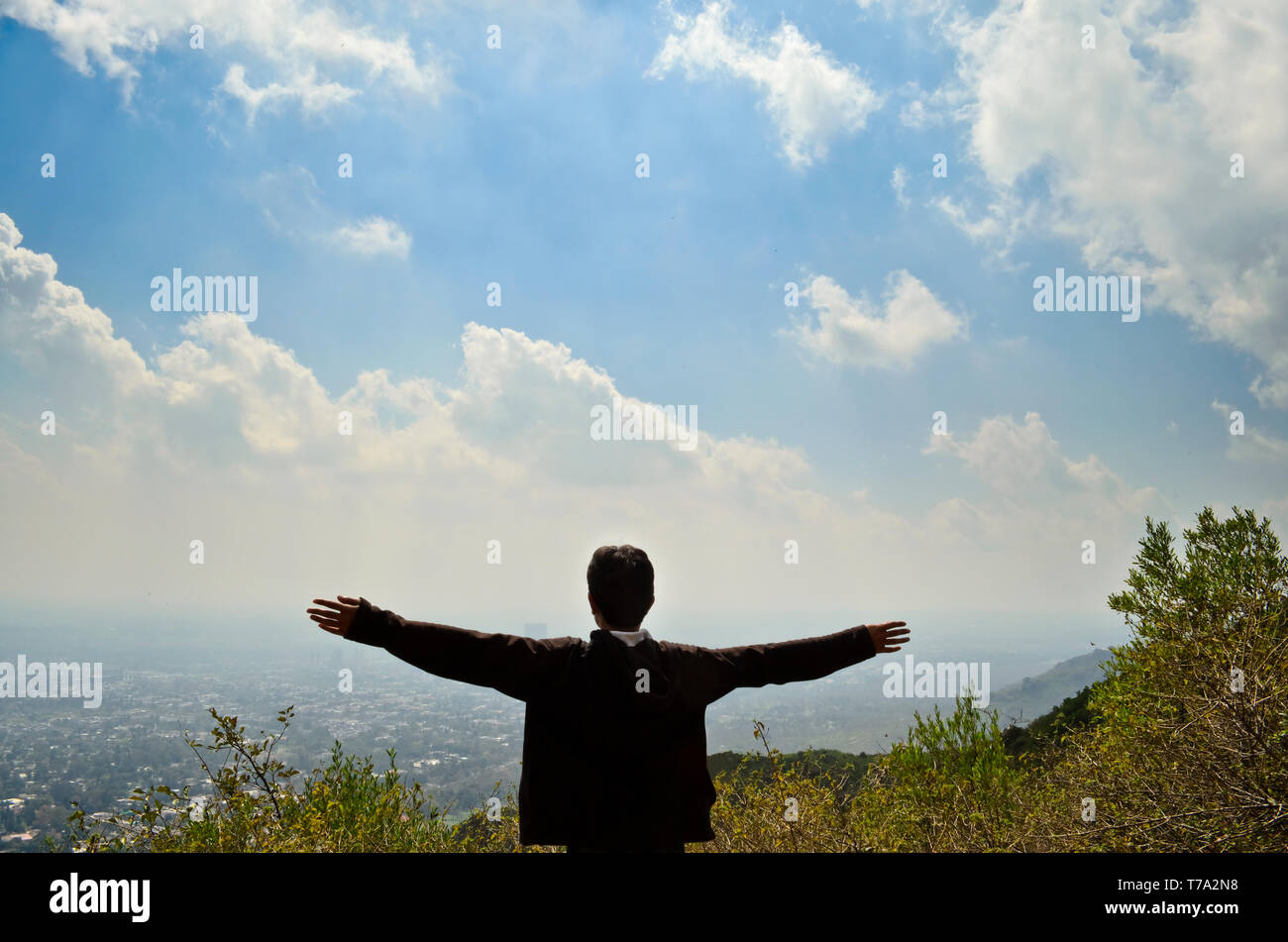 A man with wide open arms embracing the nature on a hill Stock Photo ...