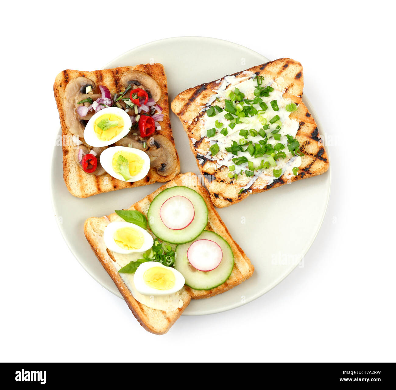 Plate with different delicious toasts on white background Stock Photo ...