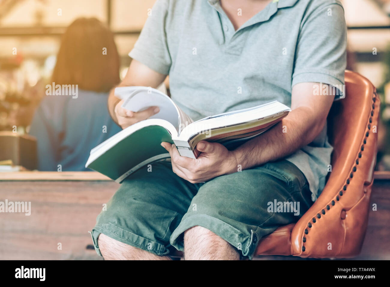 Asian man read a book in a coffee shop Stock Photo - Alamy