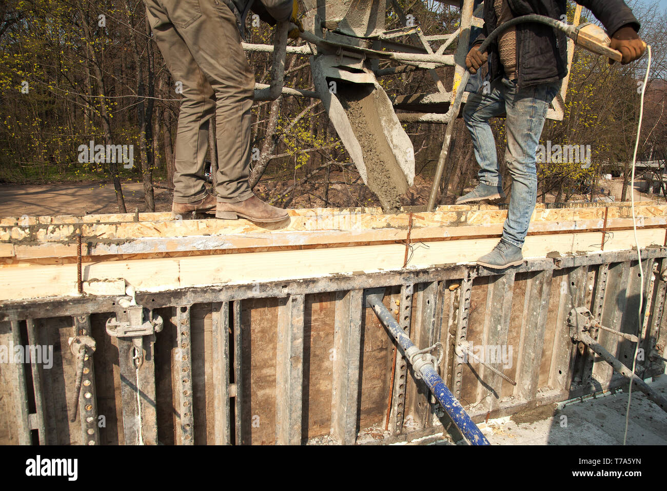 Pouring concrete into the construction of the house. Builders are ...