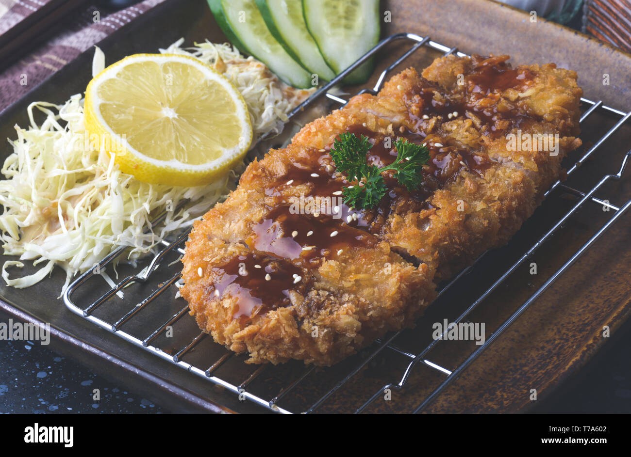 Deep fried pork in Japanese style name tonkatsu set in grey tone color ...