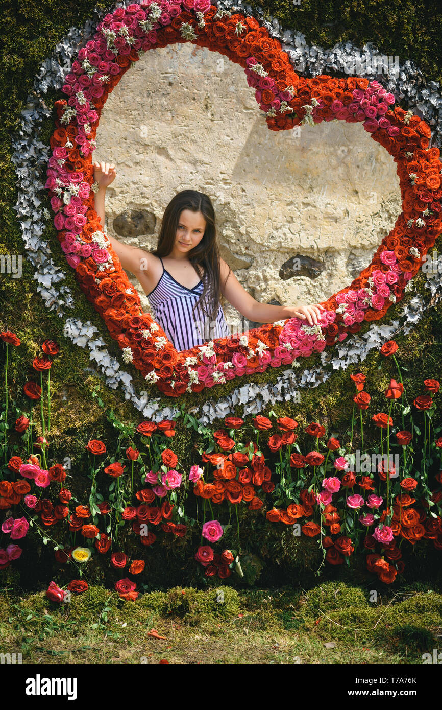 Love heart floral frame with little girl Stock Photo - Alamy