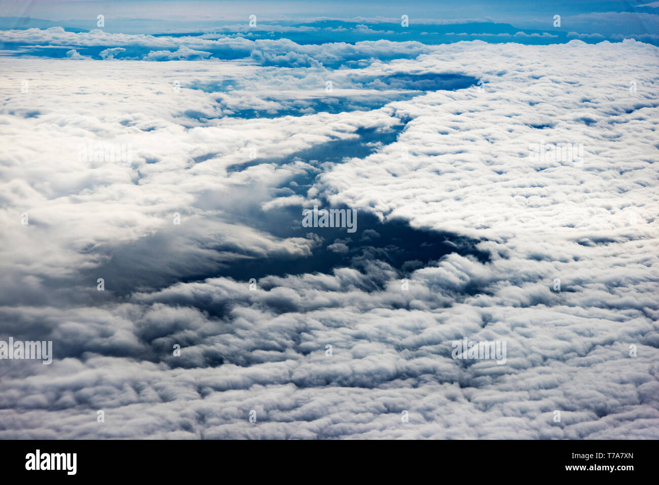 Clouds from a window of a commercial plane with sea Stock Photo - Alamy