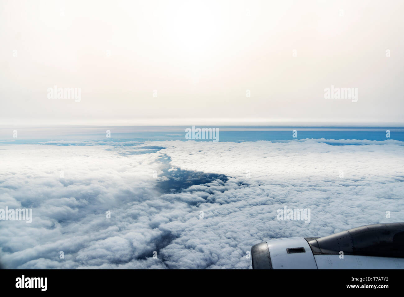 Clouds from a window of a commercial plane with sea Stock Photo - Alamy