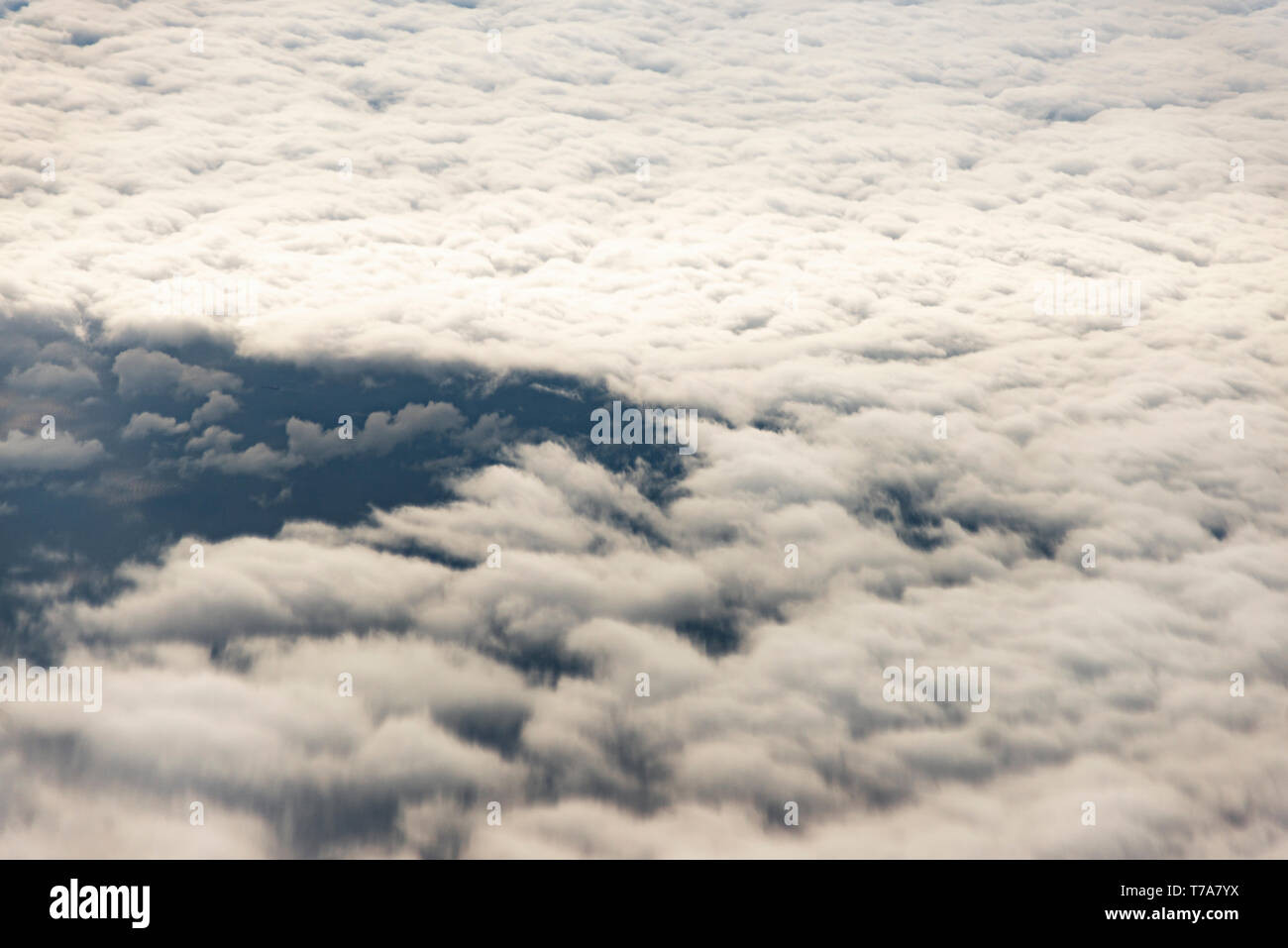 Clouds from a window of a commercial plane with sea Stock Photo - Alamy