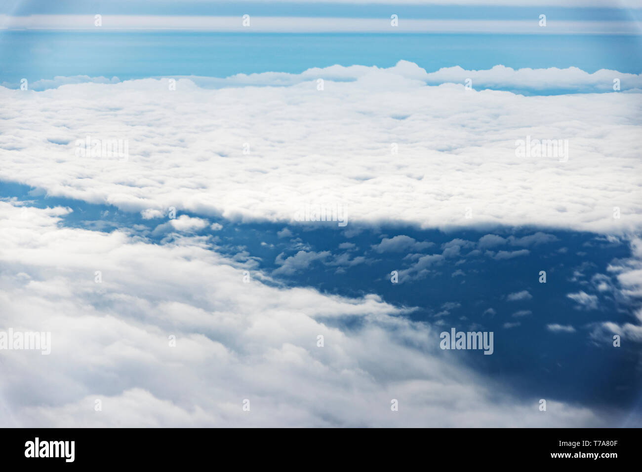 Clouds from a window of a commercial plane with sea Stock Photo - Alamy