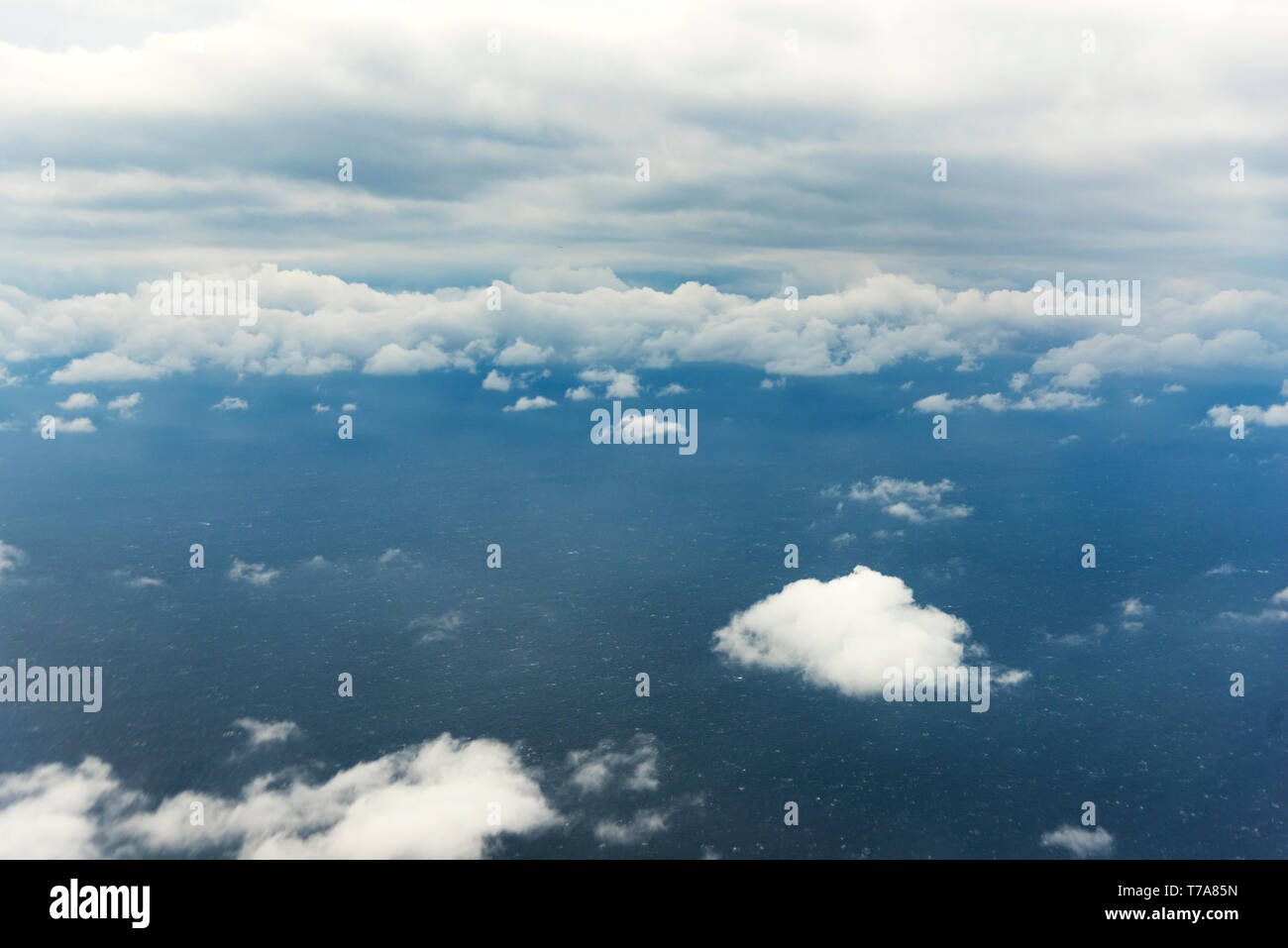 Clouds from a window of a commercial plane with sea Stock Photo - Alamy