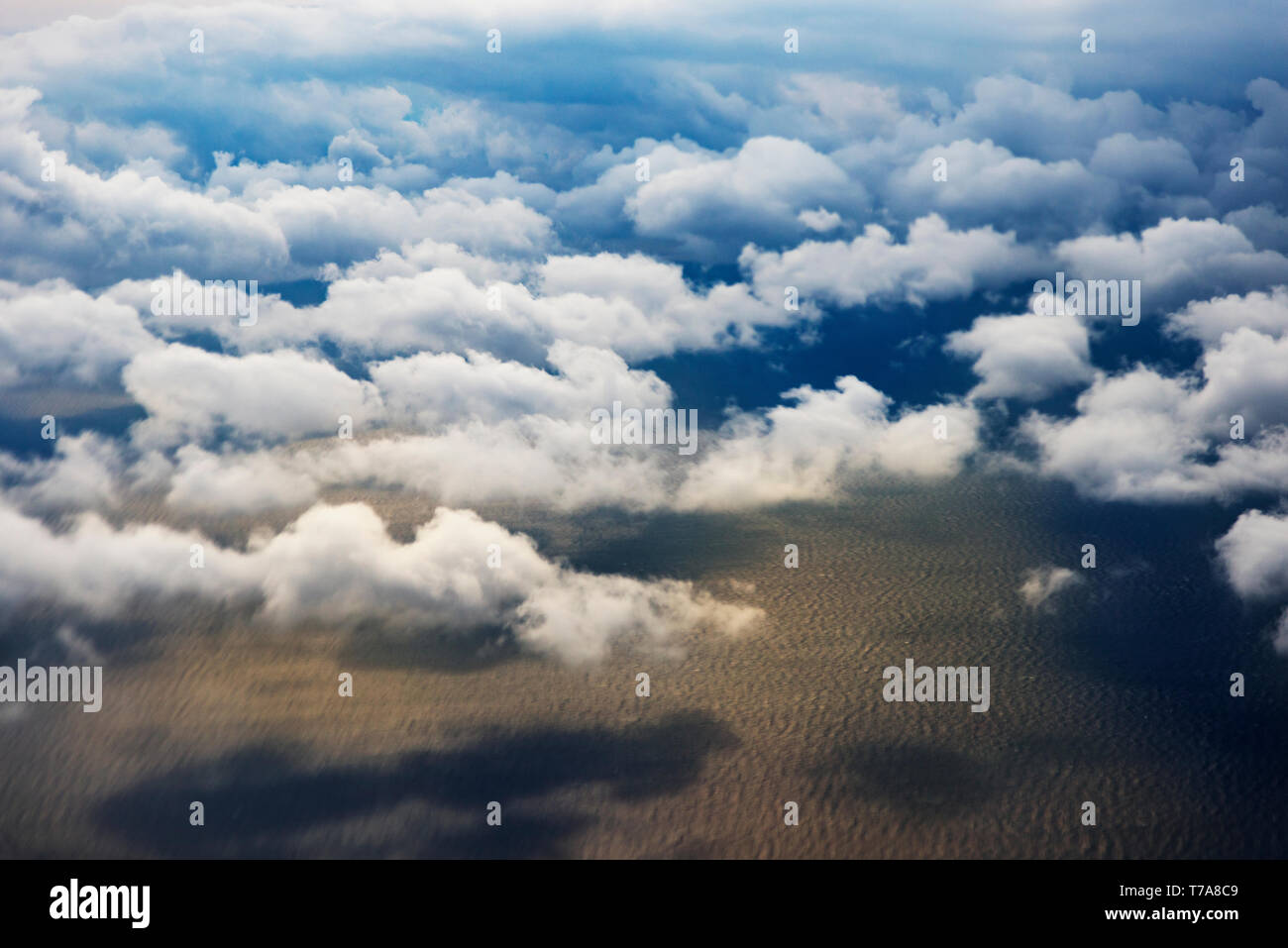 Clouds from a window of a commercial plane with sea Stock Photo - Alamy