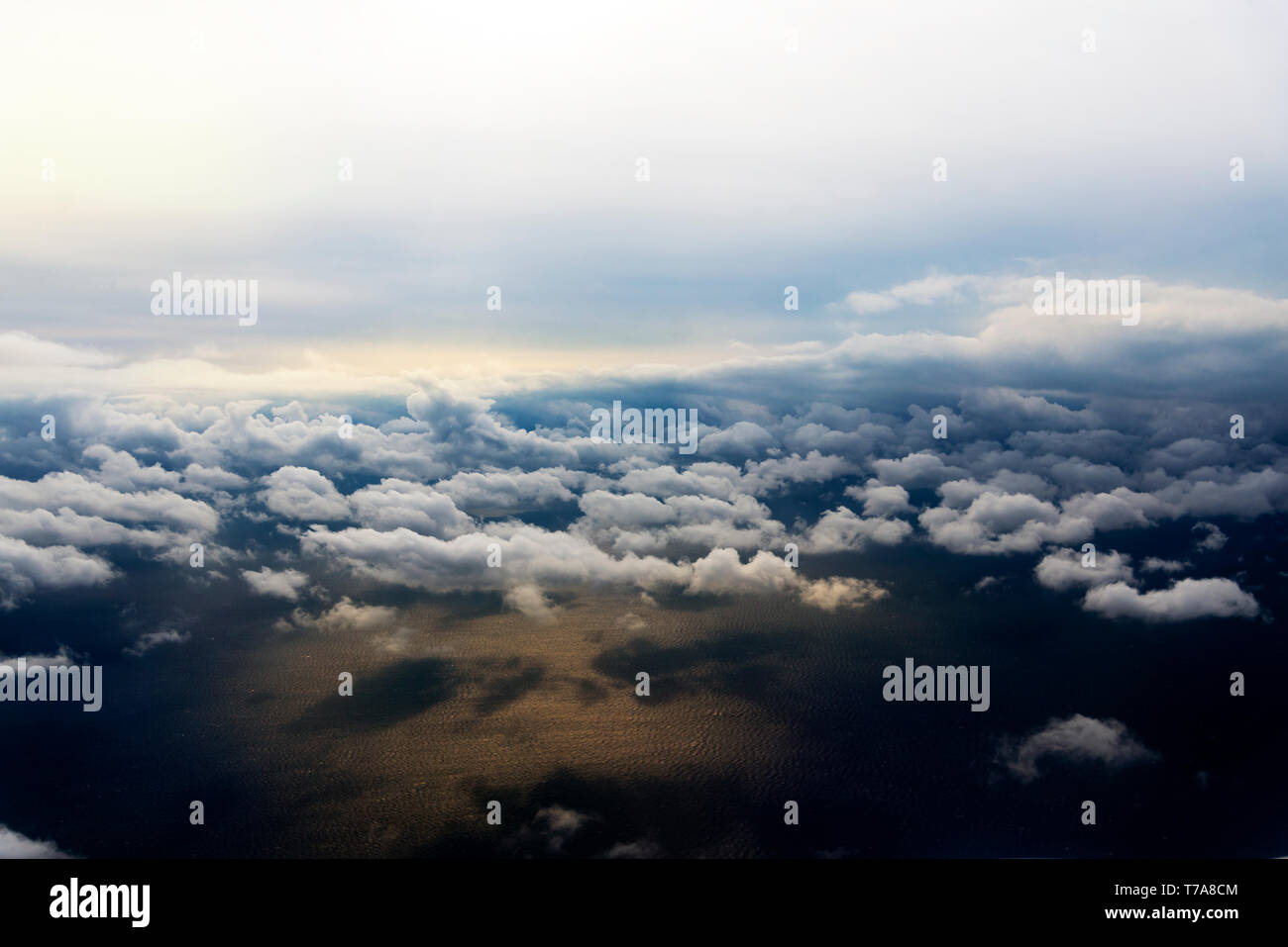 Clouds from a window of a commercial plane with sea Stock Photo - Alamy