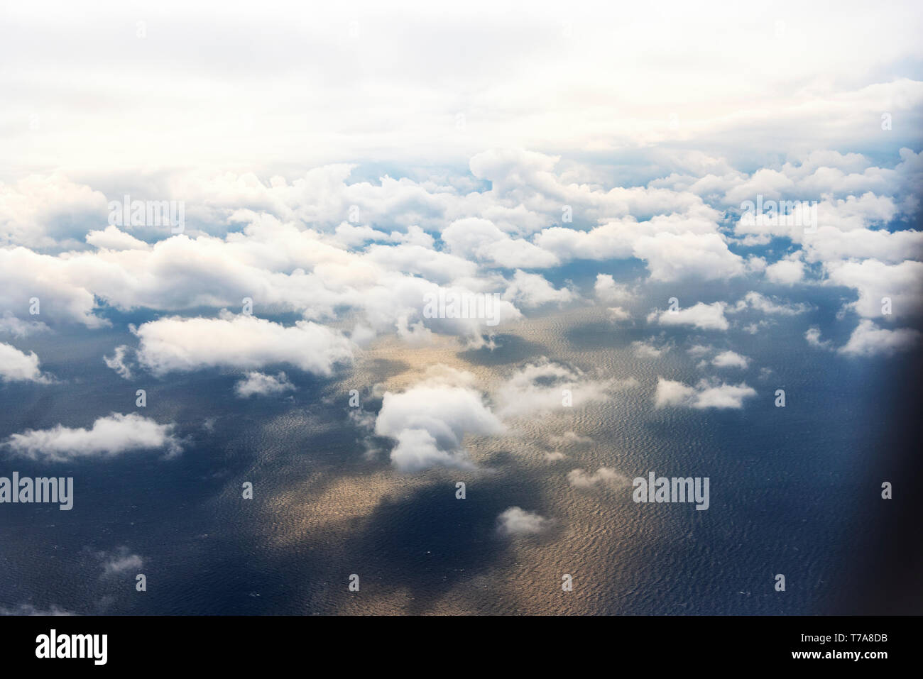 Clouds from a window of a commercial plane with sea Stock Photo - Alamy