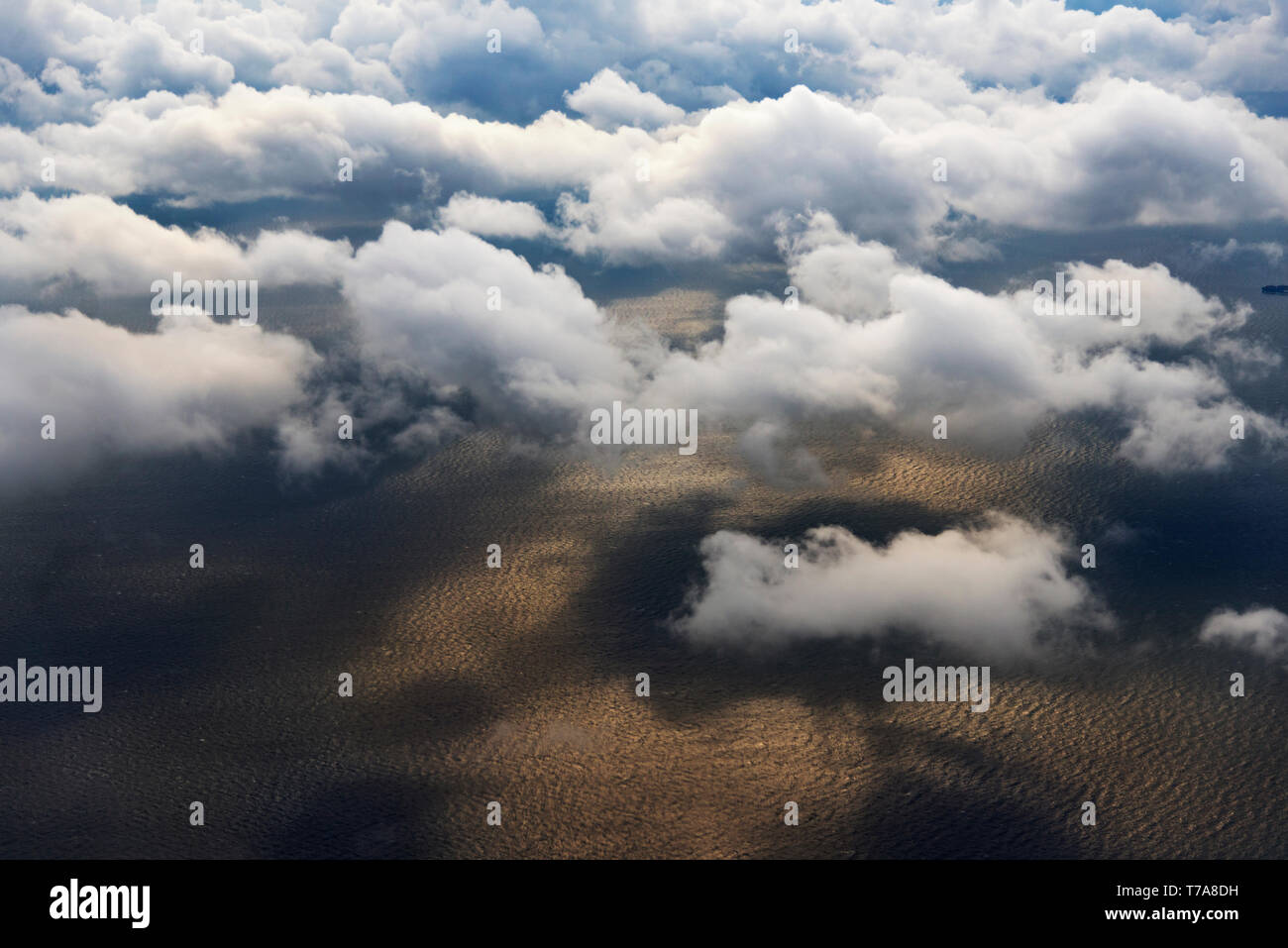 Clouds from a window of a commercial plane with sea Stock Photo - Alamy