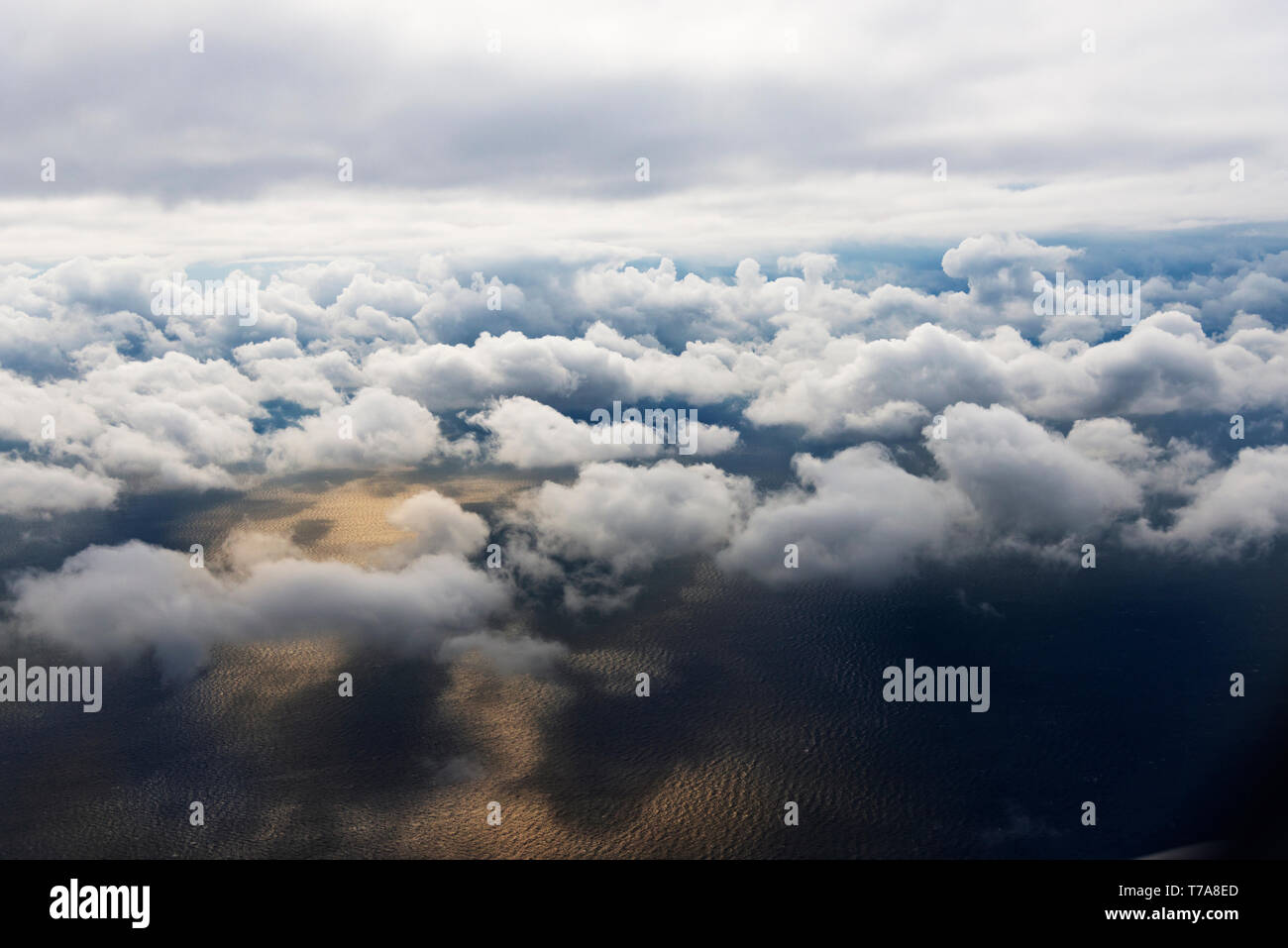 Clouds from a window of a commercial plane with sea Stock Photo - Alamy