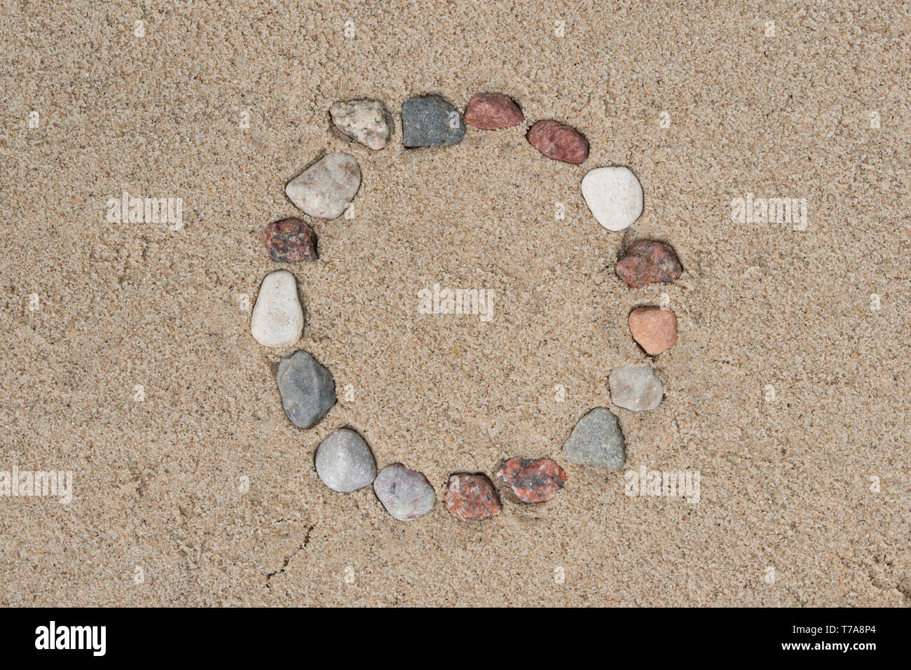 round frame made of pebble stones on sand background texture Stock ...