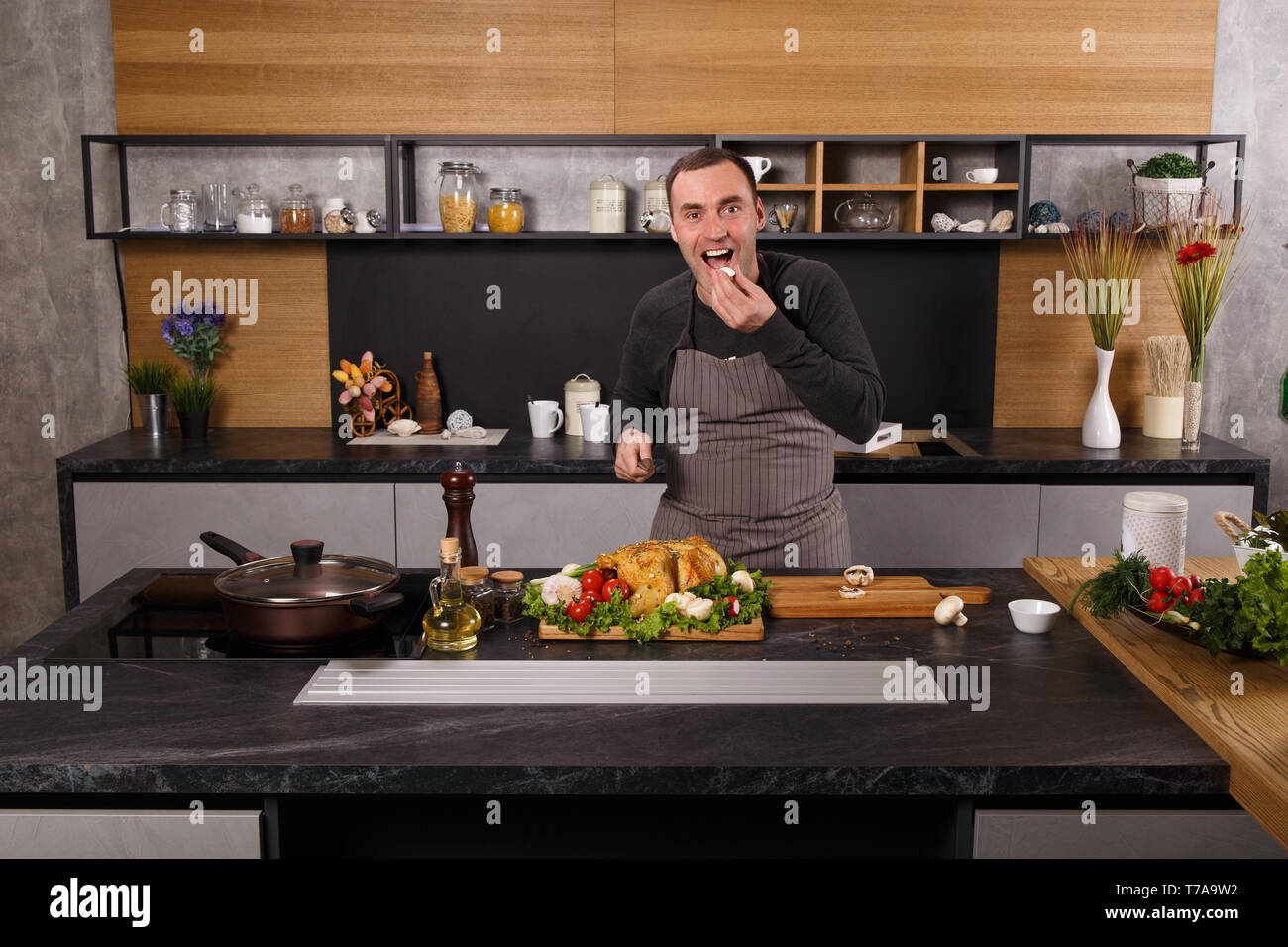 Portrait of handsome cook on the modern kitchen at home Stock Photo - Alamy