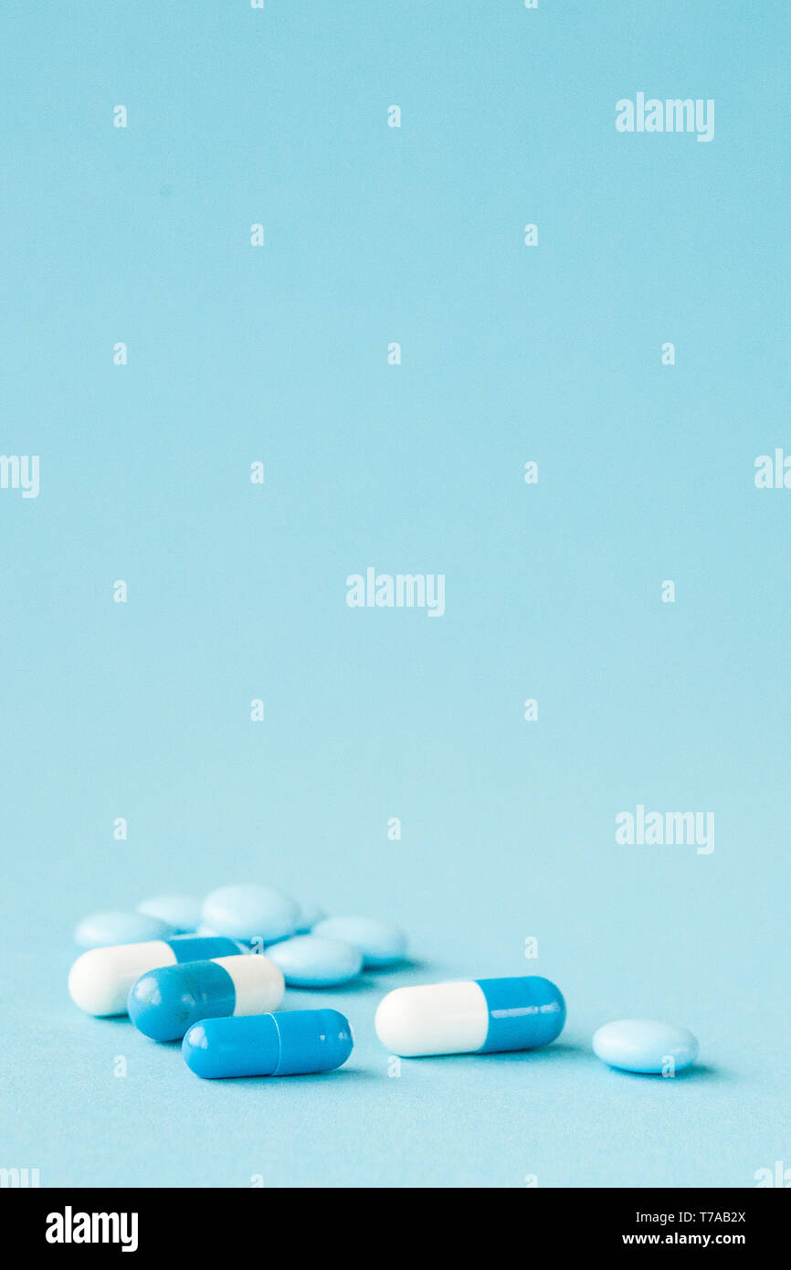 Blue pills and capsules on blue background with copy space Stock Photo ...