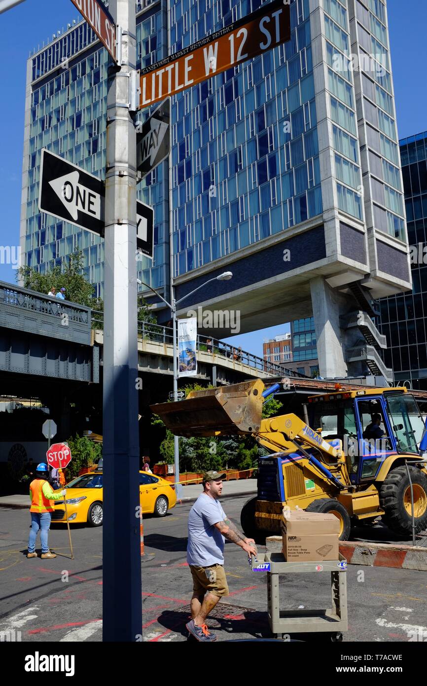 Worker with Slow sign on a road construction site in Meatpacking ...