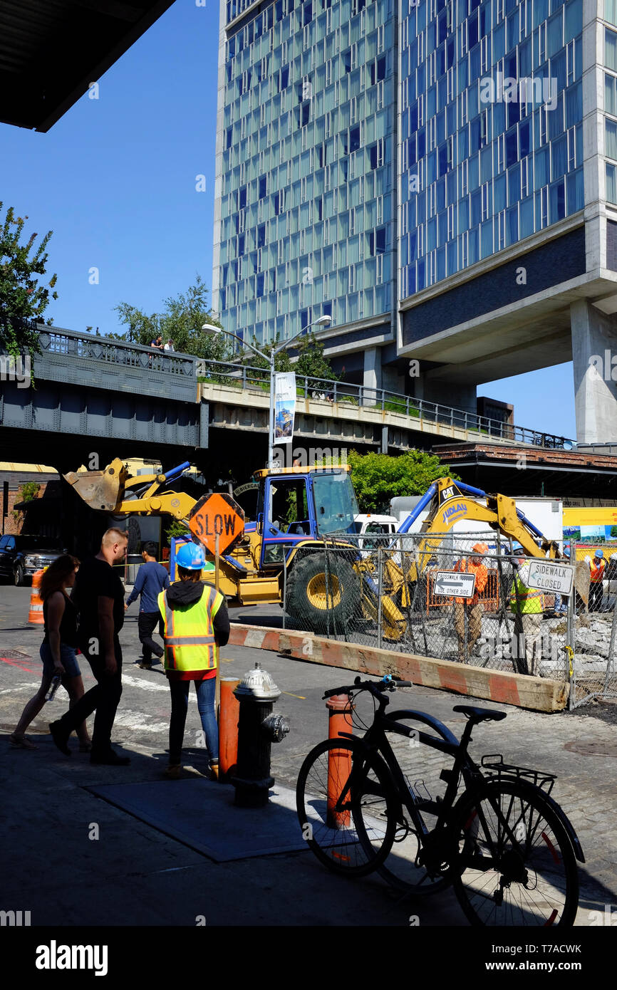 Worker with Slow sign on a road construction site in Meatpacking ...