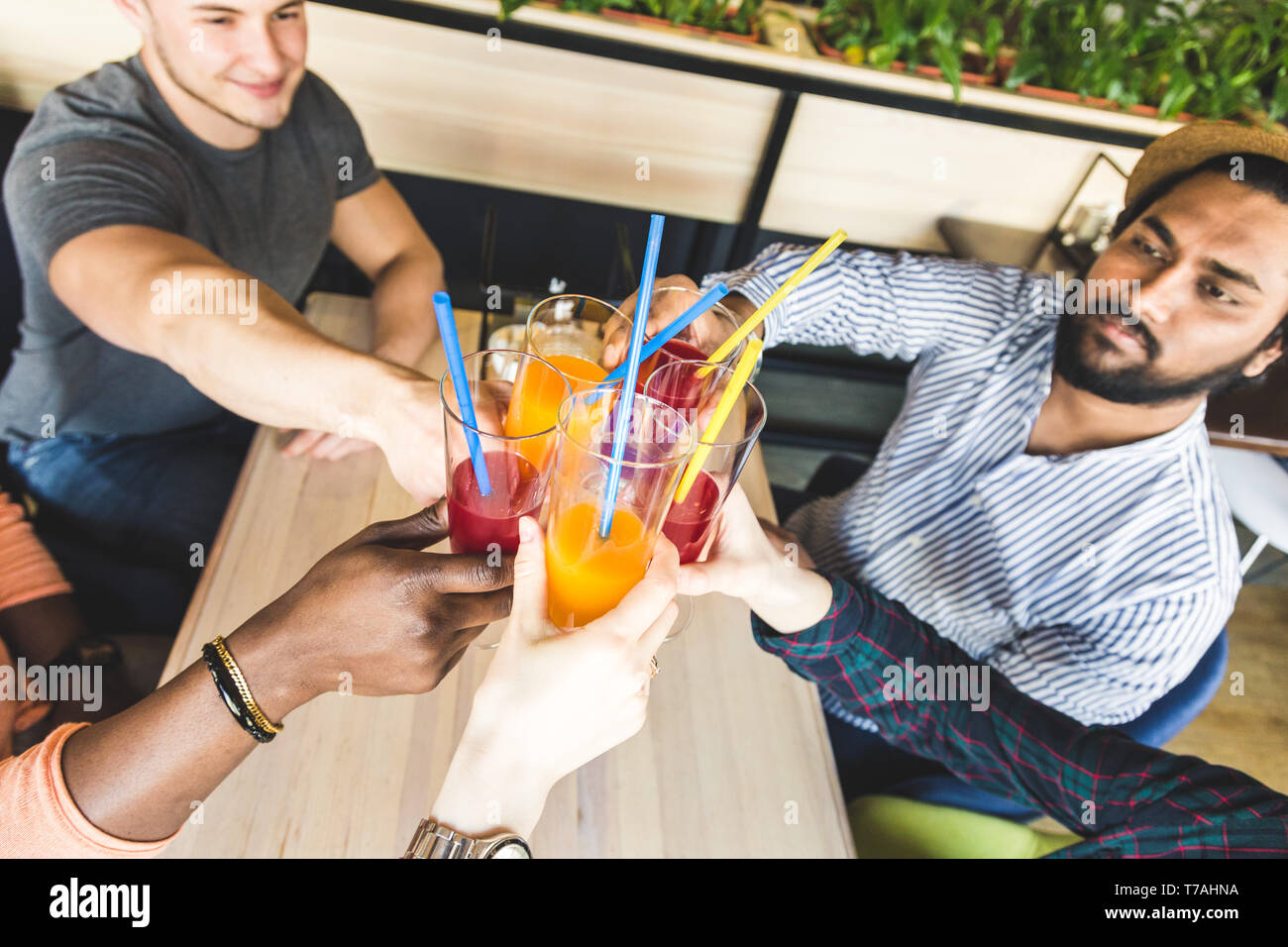 Company of young people having fun, drinking drinks, cocktails, juices ...