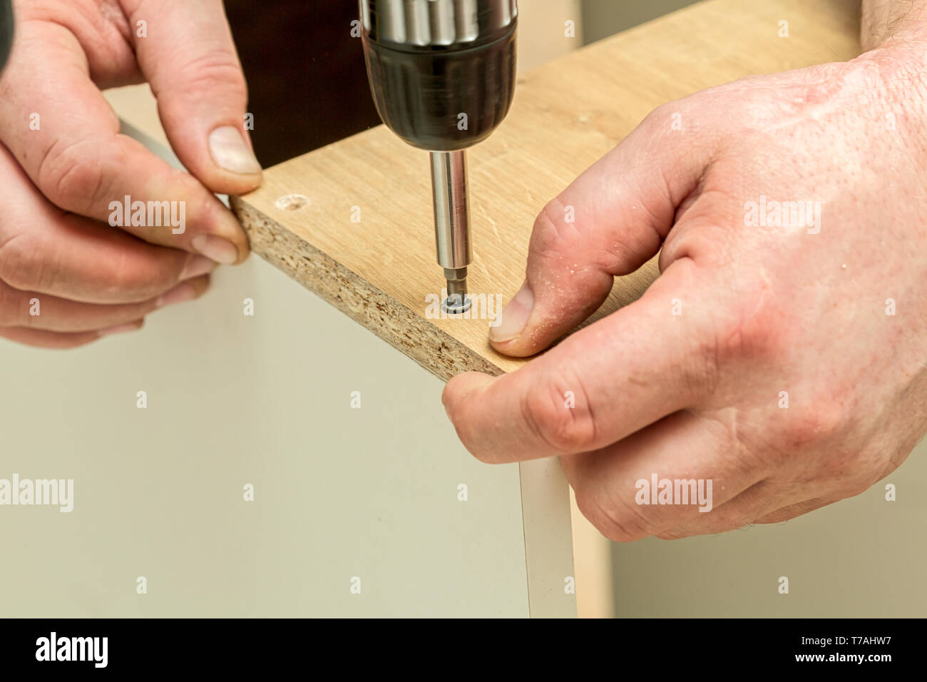 The process of furniture assembly screws closeup Stock Photo - Alamy