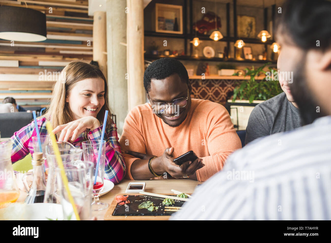 Meet young attractive people in the cafe. Friends chat, have fun, drink ...