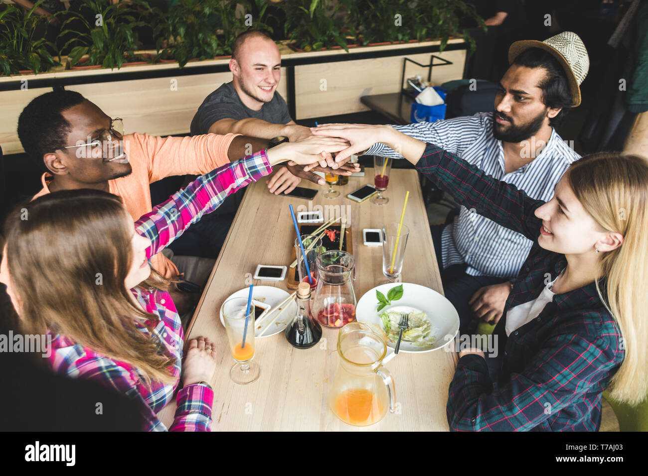 Meet young attractive people in the cafe. Friends chat, have fun, drink ...