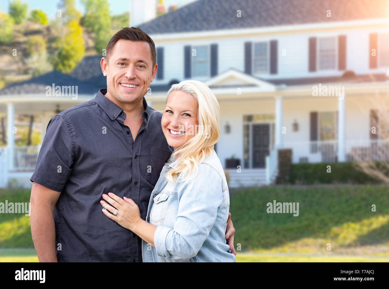 Happy Couple In Front of Beautiful House Stock Photo - Alamy