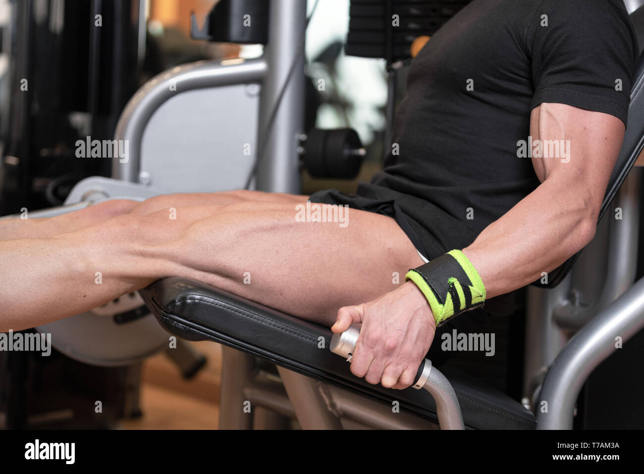 Handsome strong man performed leg press workout in the gym Stock Photo ...