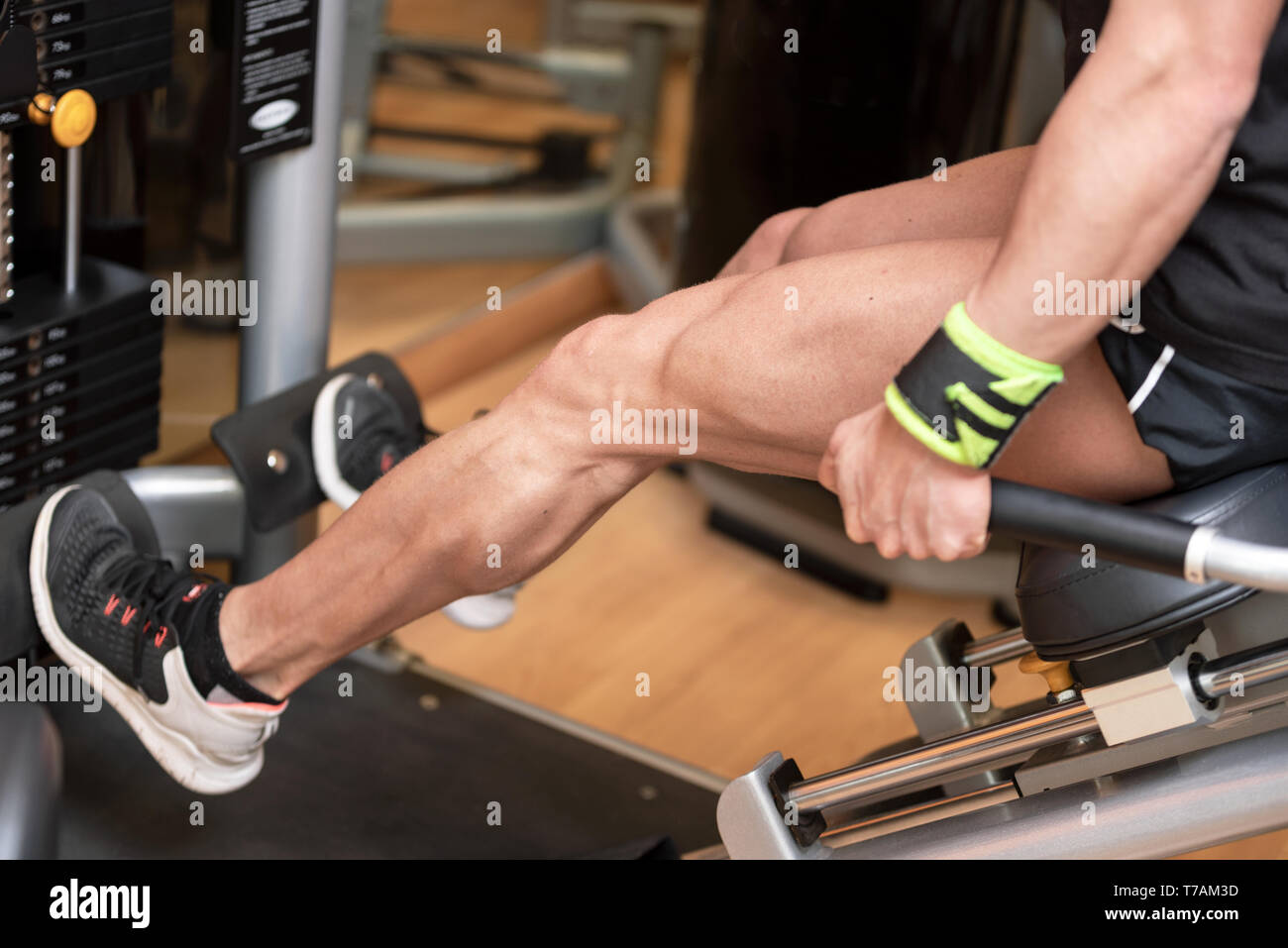 Handsome strong man performed leg press workout in the gym Stock Photo ...