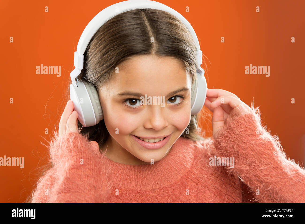 Girl cute little child wear headphones listen music. Kid listen music ...