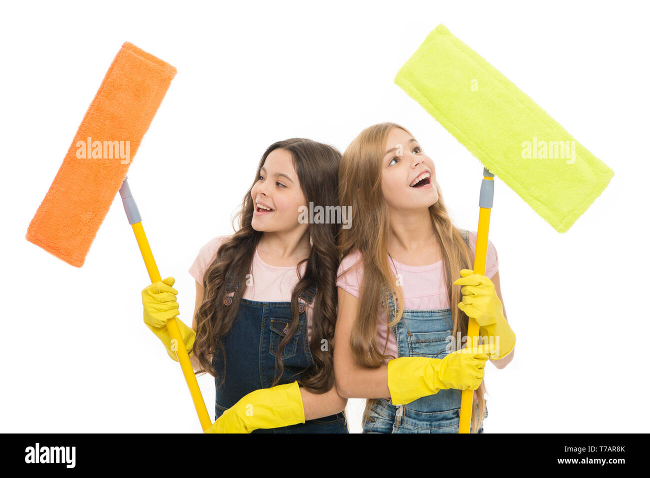 Helpful kids cleaning together. Girls with protective gloves and mops ...