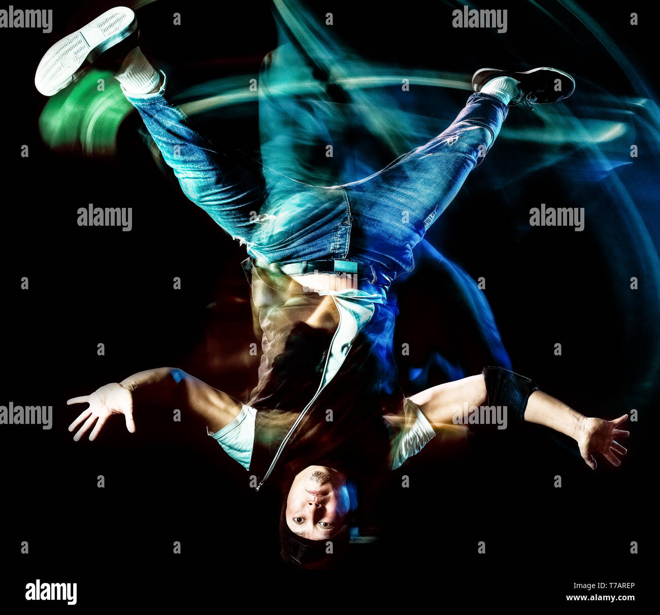 one chinese young man hip hop break dancer dancing isolated on black ...